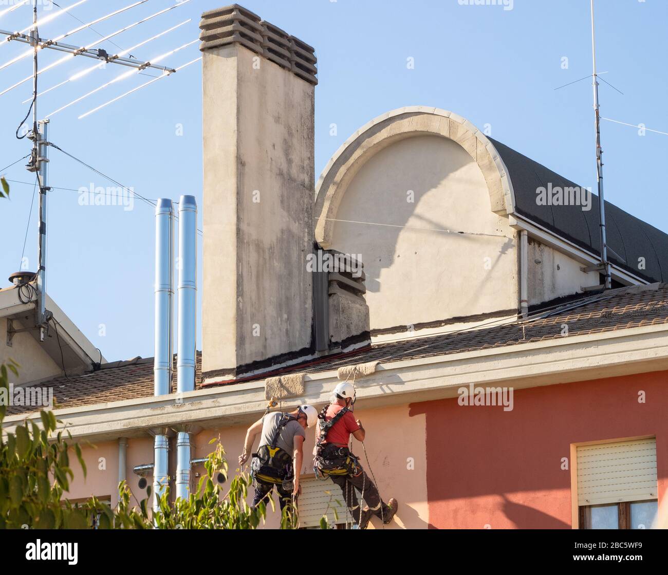 maintenance work on the roof and facade of a building carried out ...