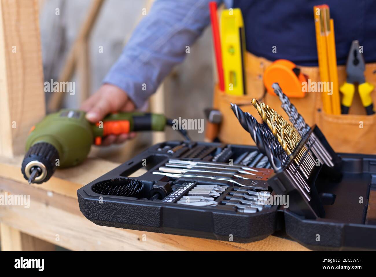 Close up picture of carpenters tool belt and work instruments on wooden ...