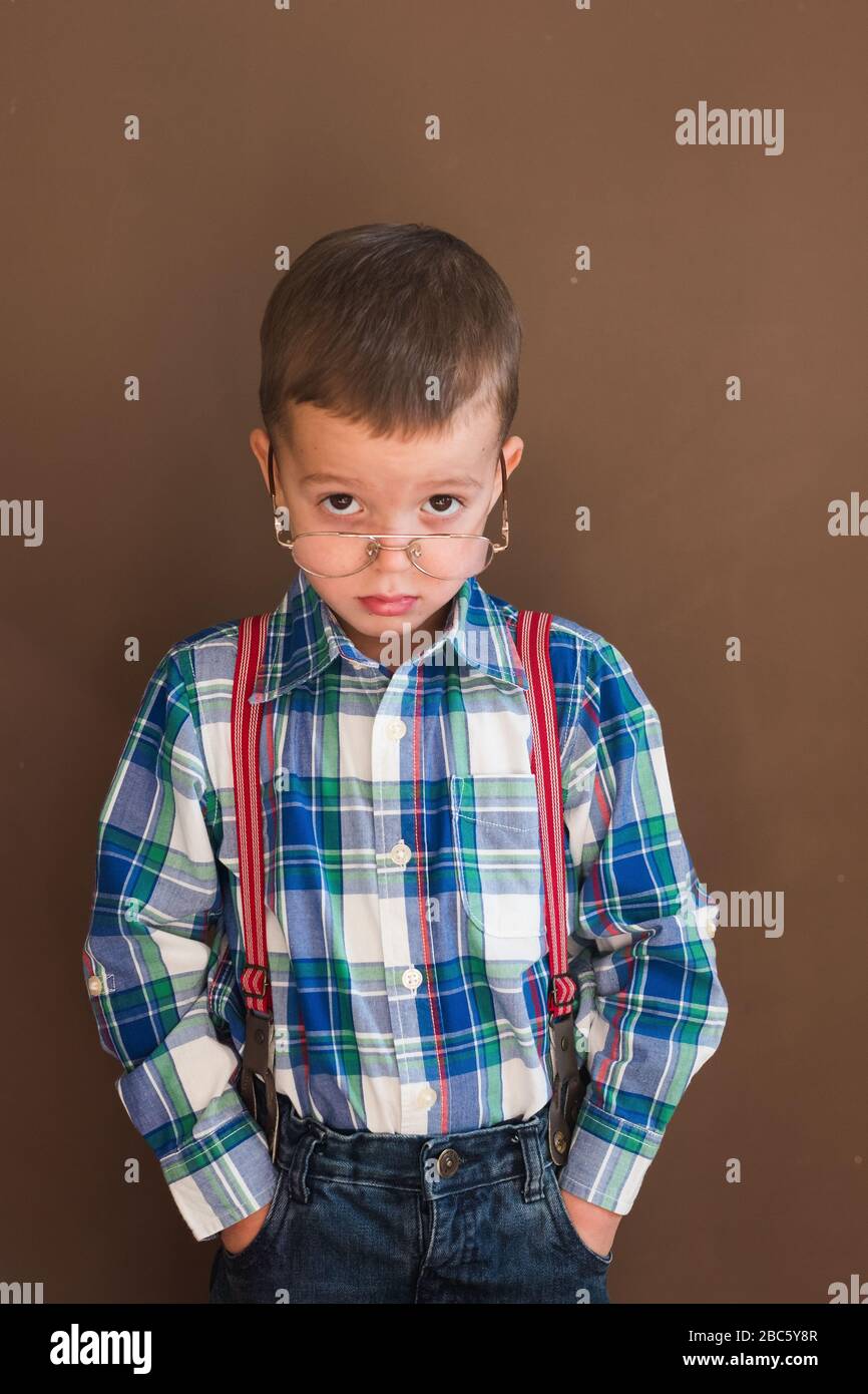 Portrait of smart stylish little boy. Little child in glasses has idea ...