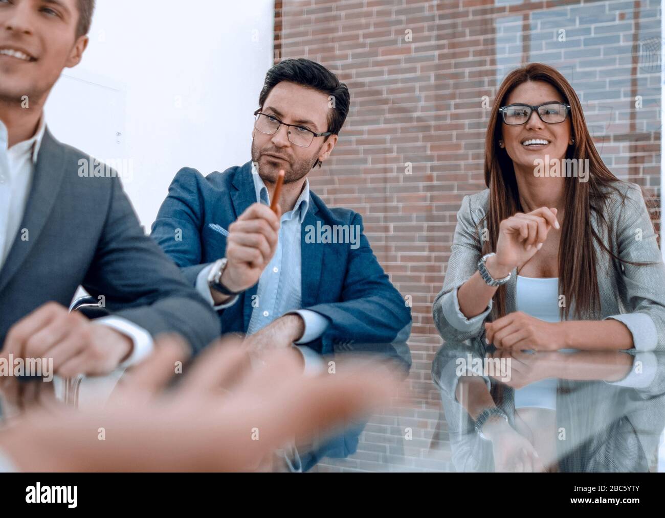 business team sitting at the office Desk Stock Photo - Alamy