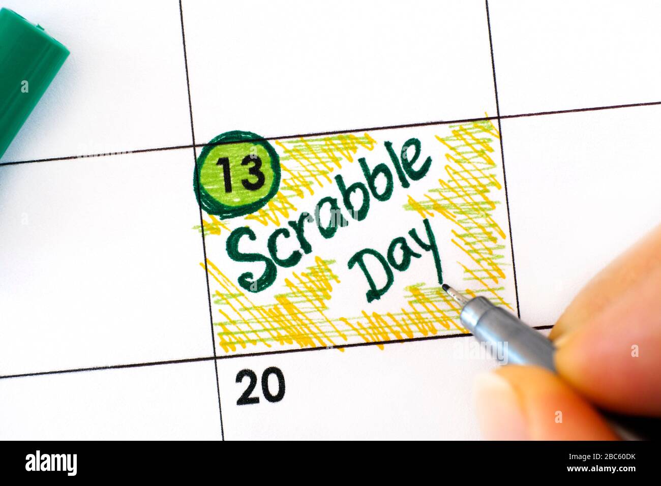 Woman Fingers With Pen Writing Reminder Scrabble Day In Calendar April