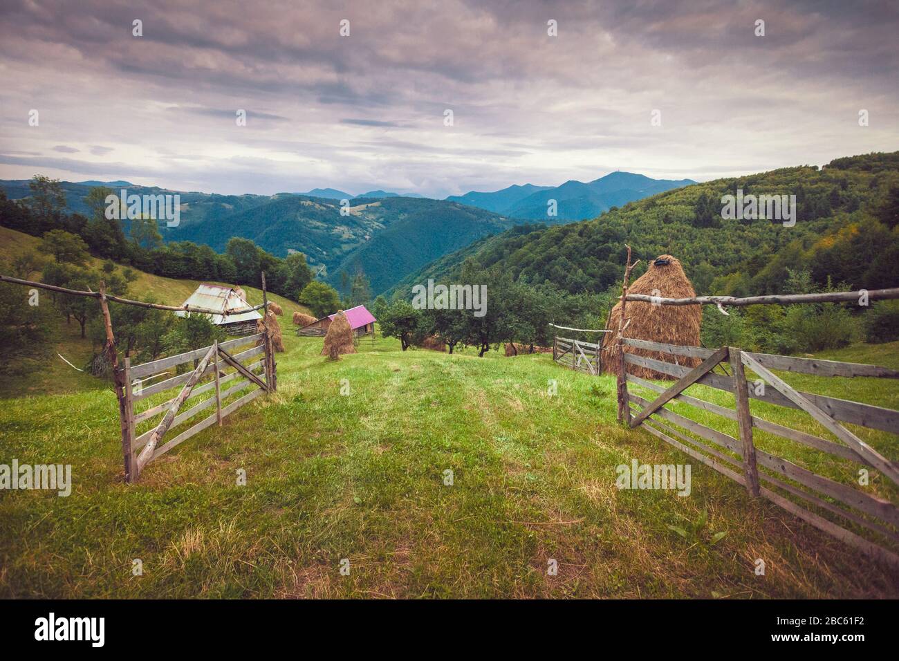 Rural landscape small village houses and haystacks Stock Photo - Alamy