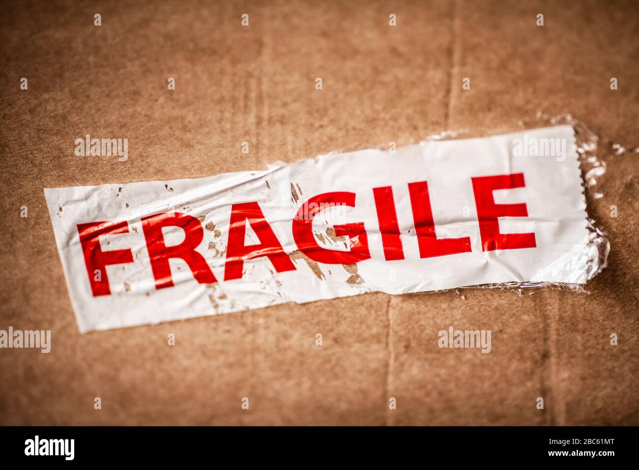 Fragile tape sticker red text on white backgroud Stock Photo - Alamy