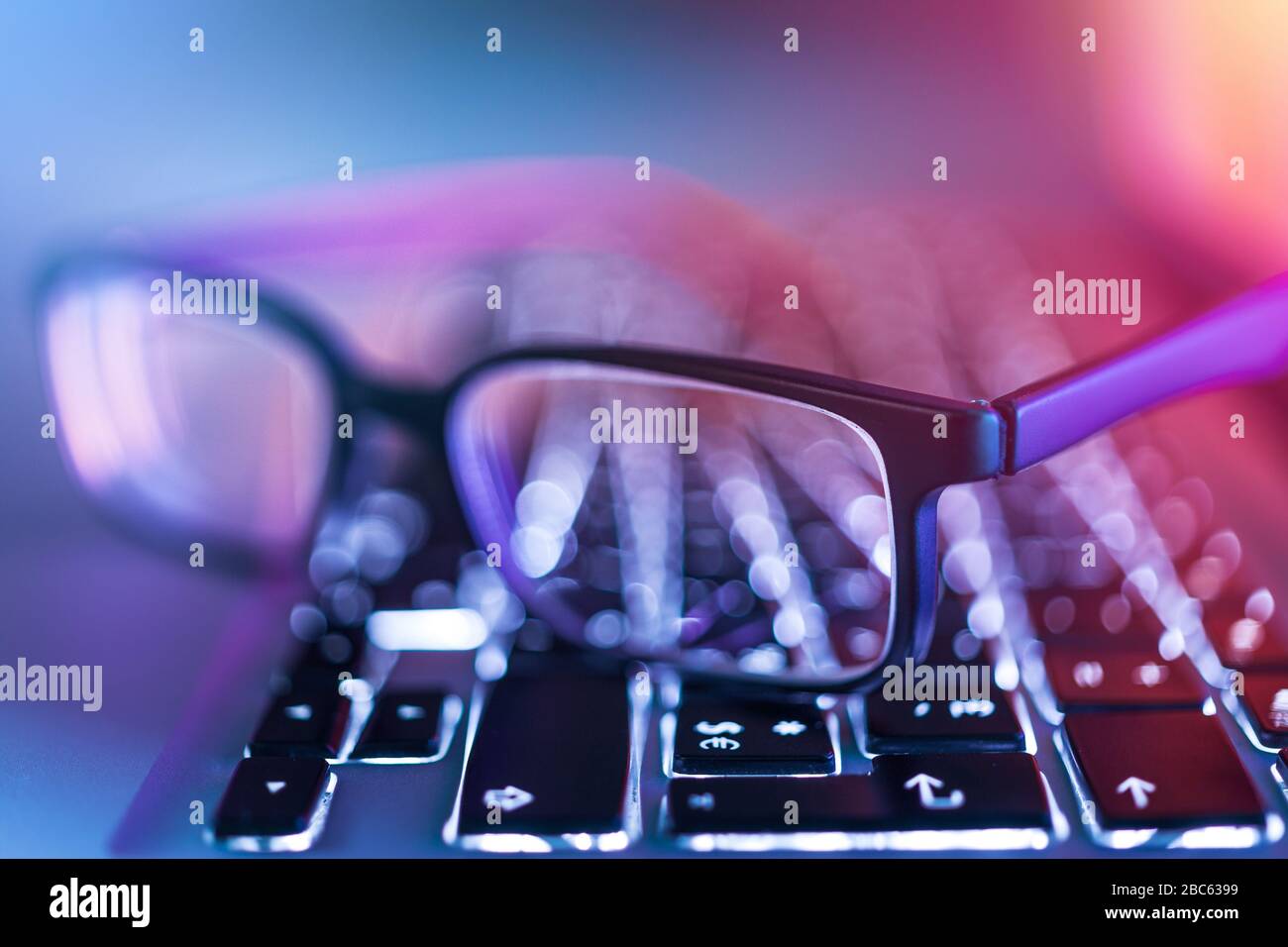 Simple glasses on laptop computer keyboard Stock Photo - Alamy