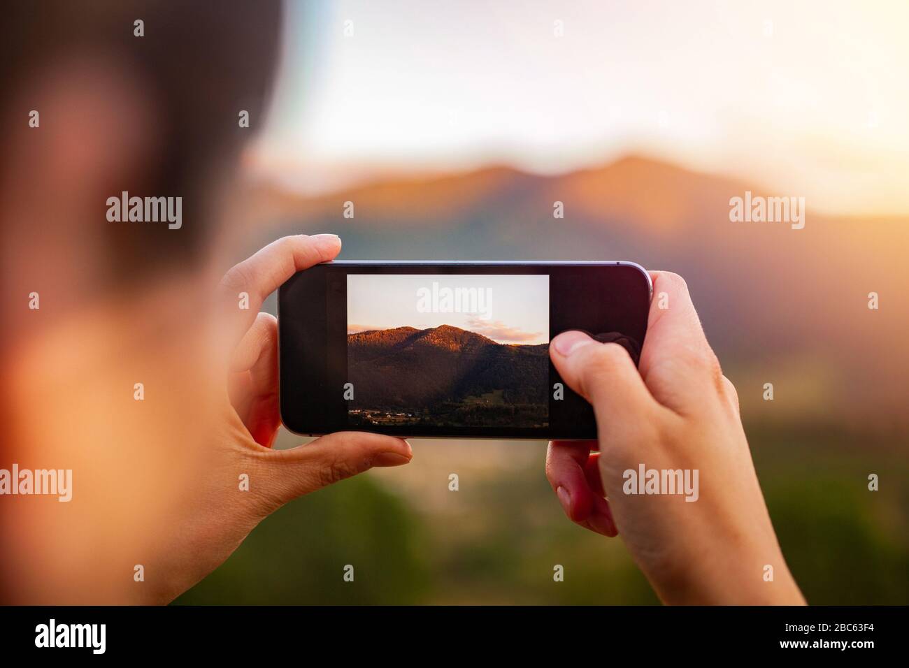 Hands holding mobile phone, taking a picture in natural scenery Stock ...