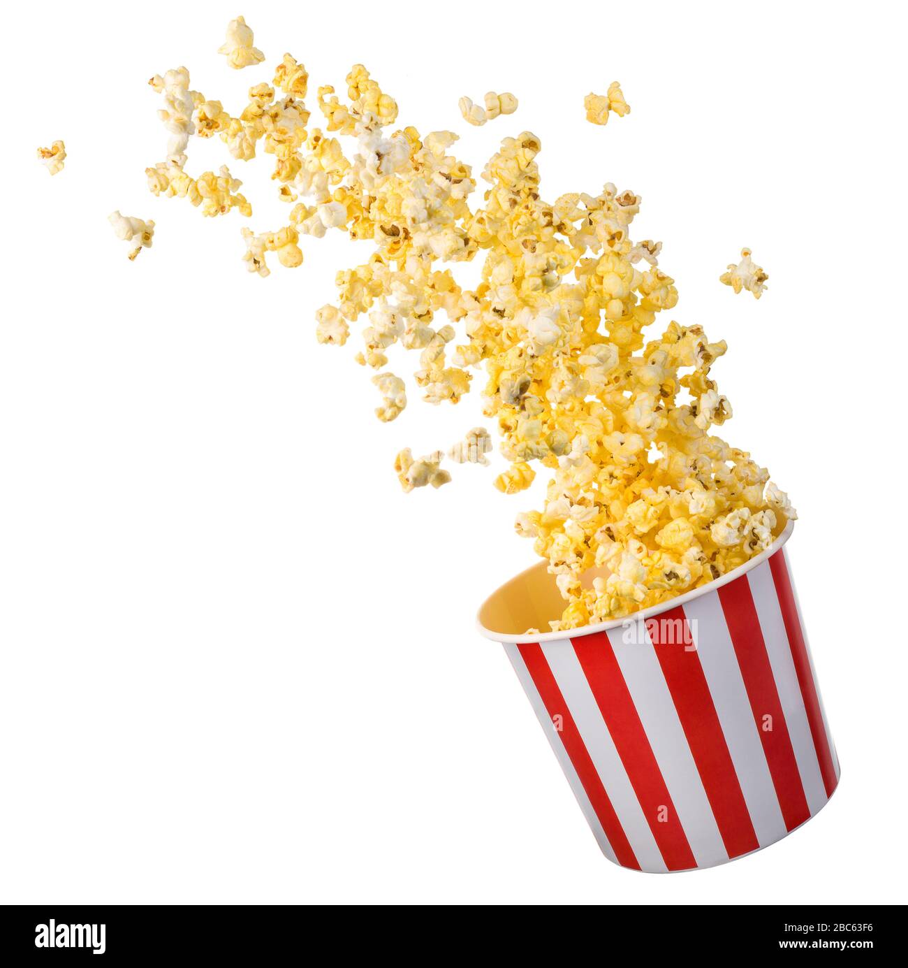 Flying popcorn from paper striped bucket isolated on black background ...