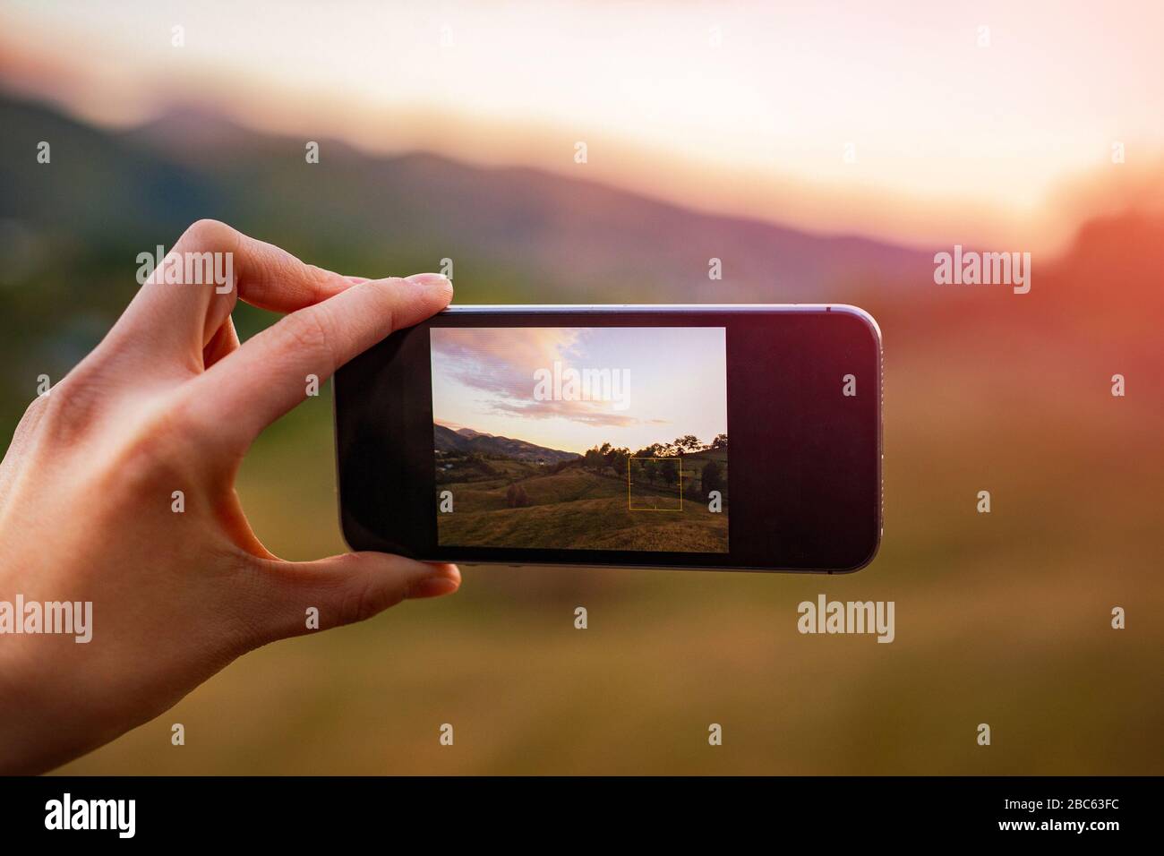 Hands holding mobile phone, taking a picture in natural scenery Stock ...