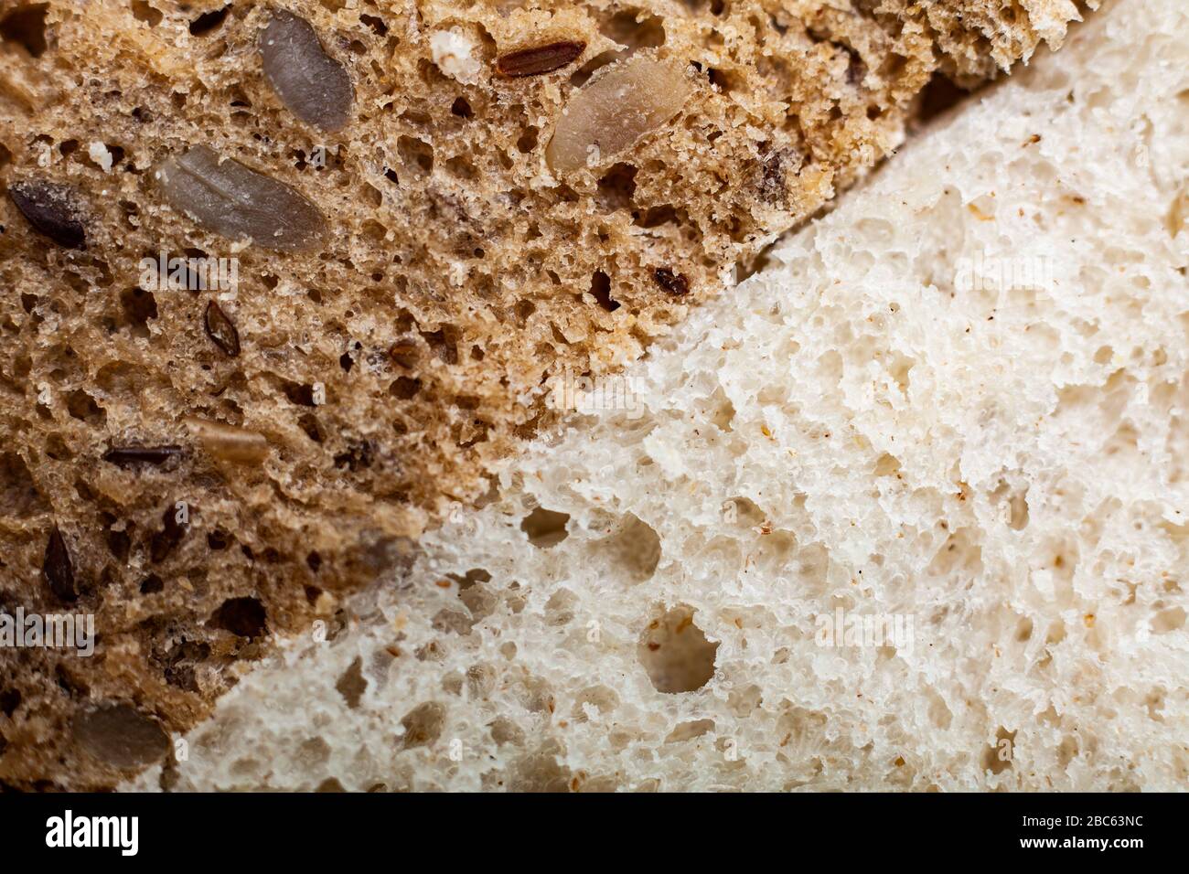 Slice of white bread and whole grain bread side by side Stock Photo - Alamy
