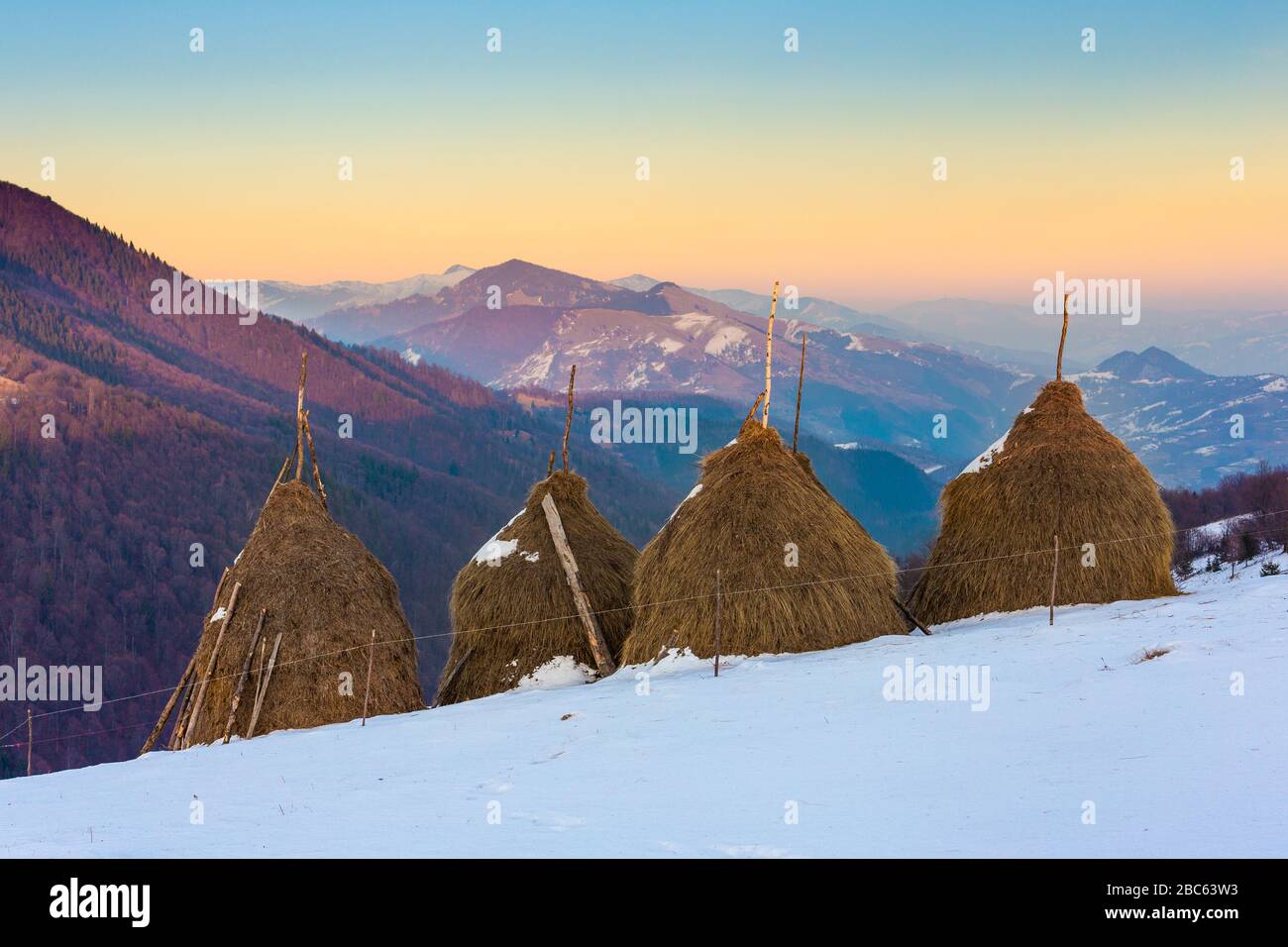 Haystack sunset landscape in winter Stock Photo - Alamy