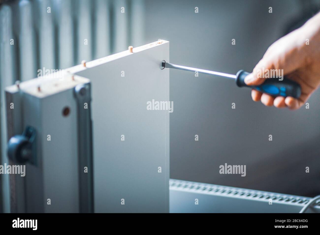 Diy furniture assembly using manual screwdriver Stock Photo - Alamy