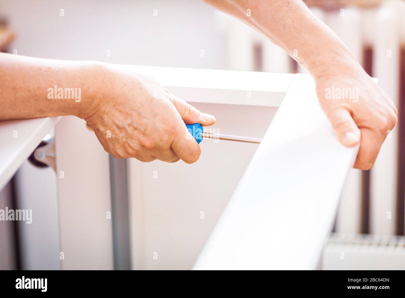 Diy furniture assembly using manual screwdriver Stock Photo - Alamy