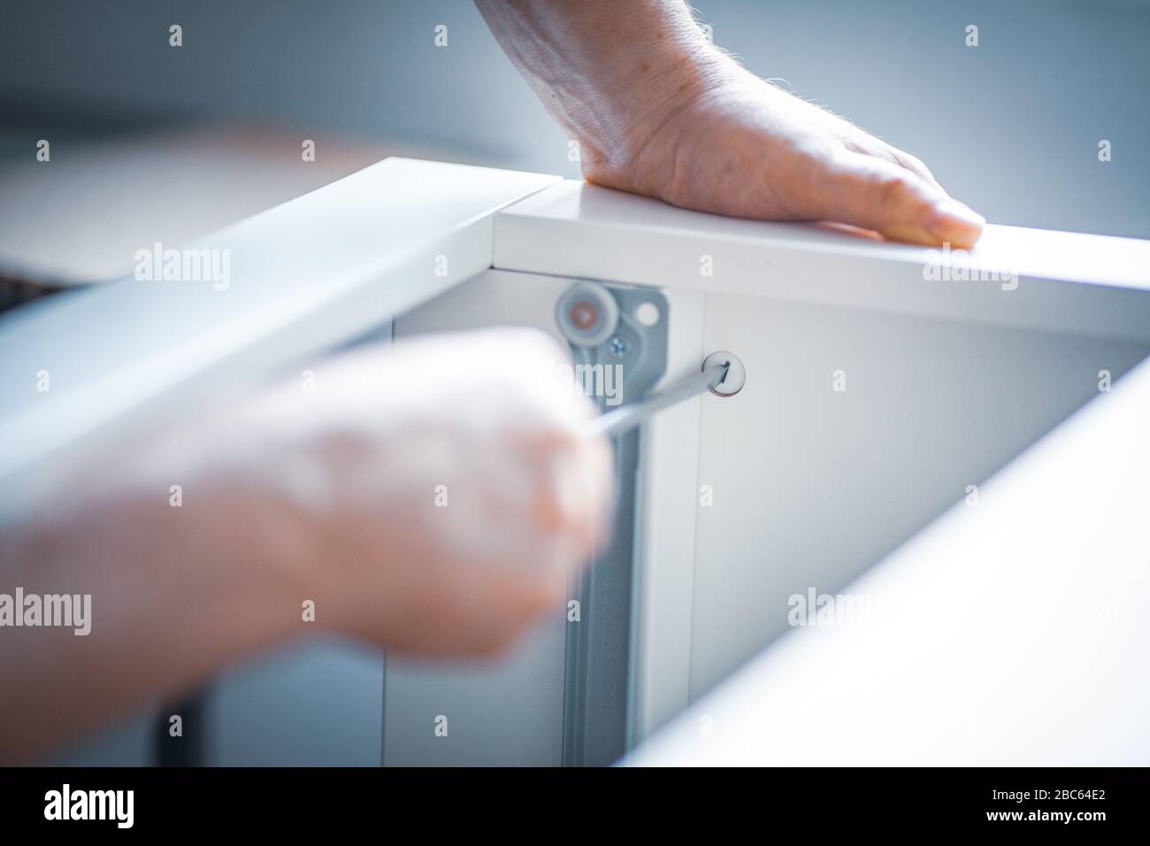 Diy furniture assembly using manual screwdriver Stock Photo - Alamy
