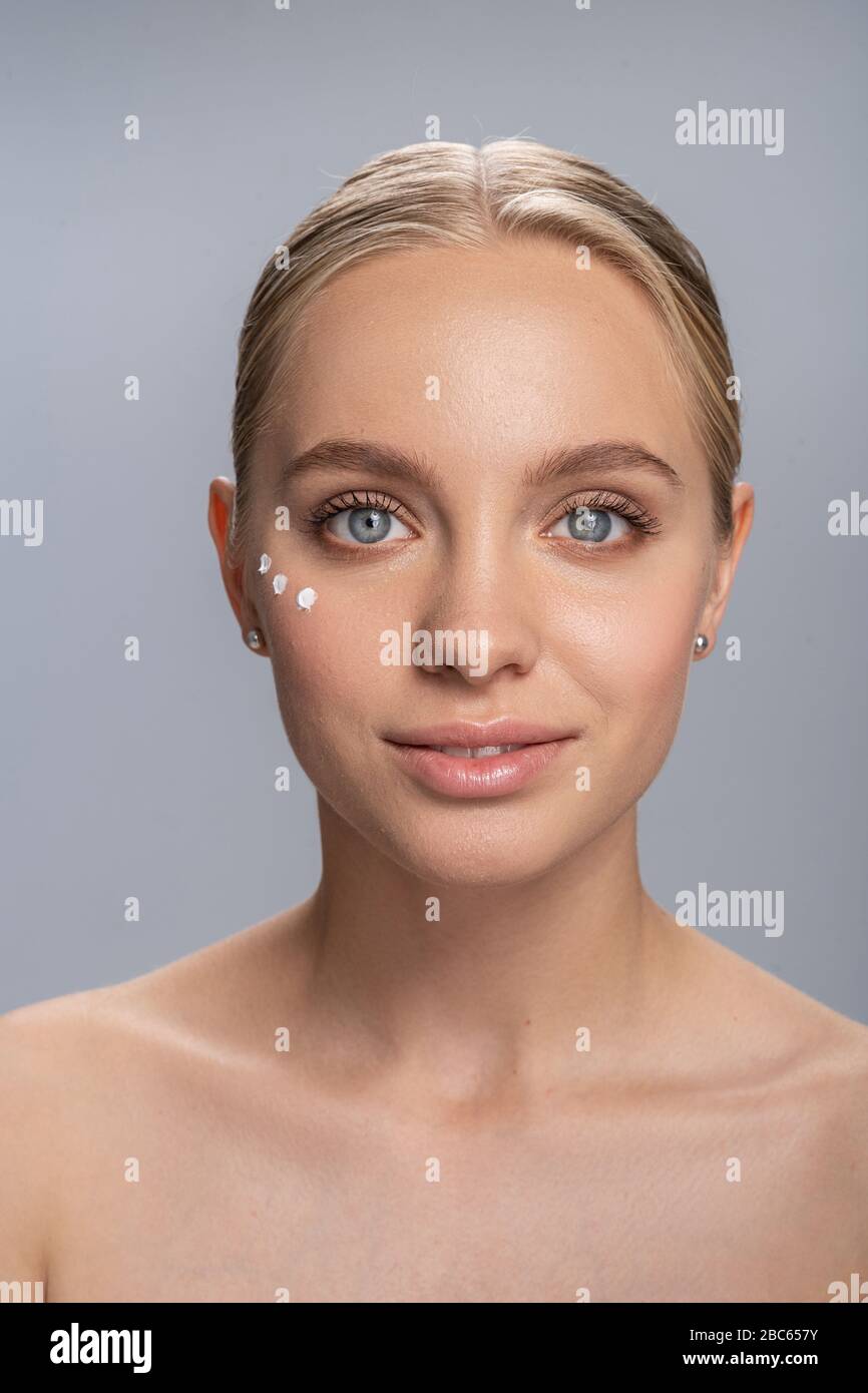 Portrait of beautiful girl that using cream Stock Photo - Alamy