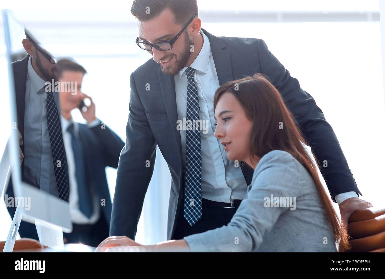 Manager talking with an employee Stock Photo - Alamy
