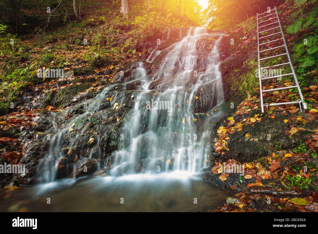 Waterfall and stairway in the woods, fresh water spring in the ...