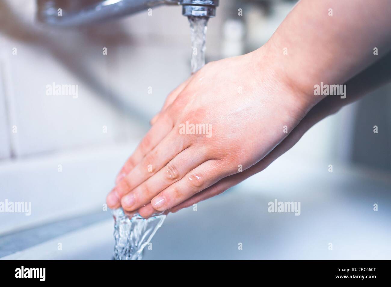 Washing hands under running water using soap, important step for a good hygiene Stock Photo - Alamy