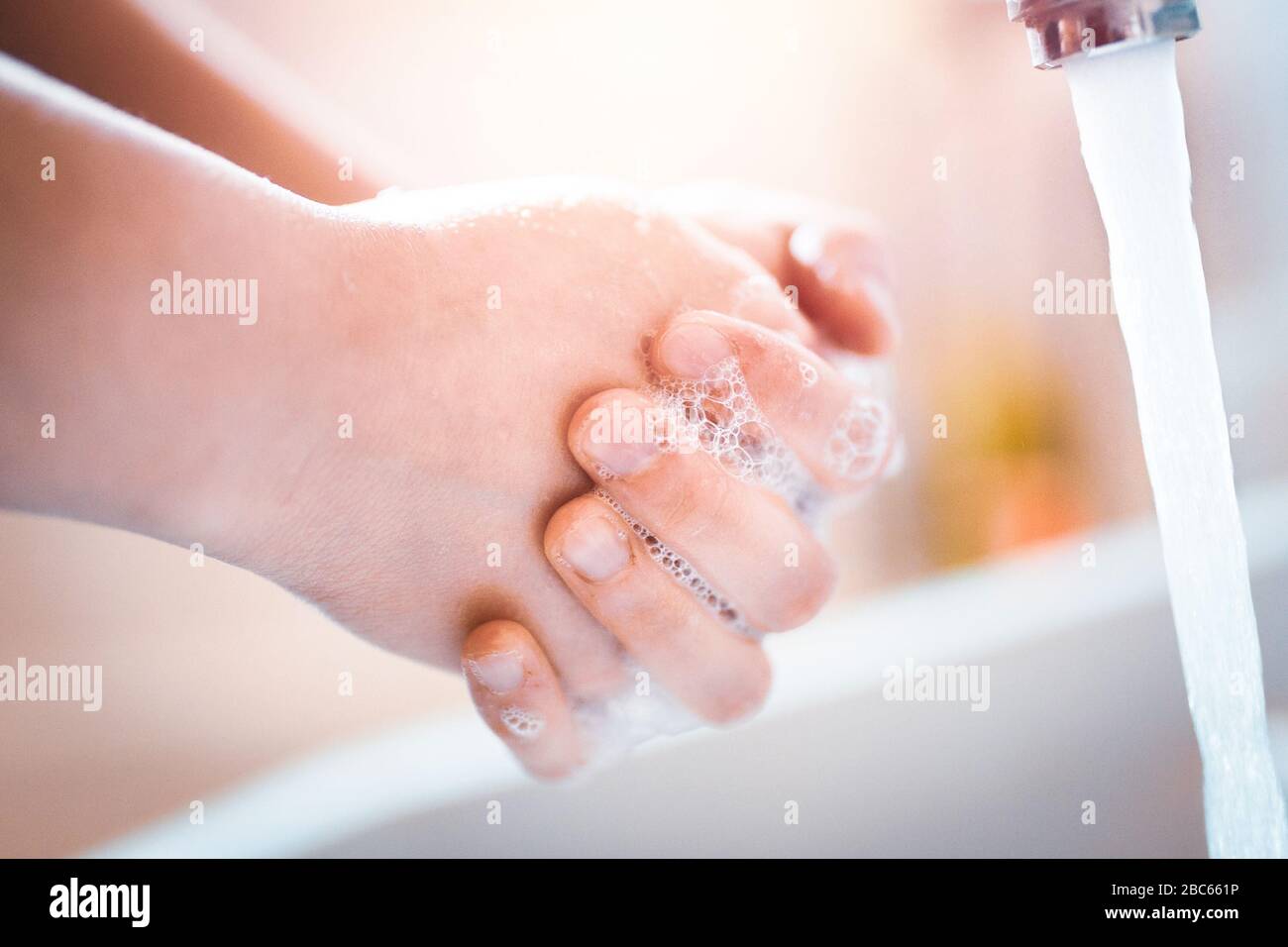 Washing hands under running water using soap, important step for a good ...