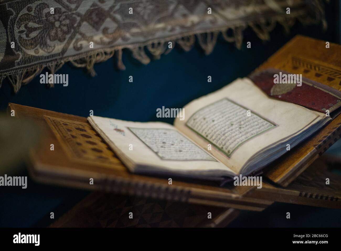 Quran islamic holy book on dark background with with blurred ...