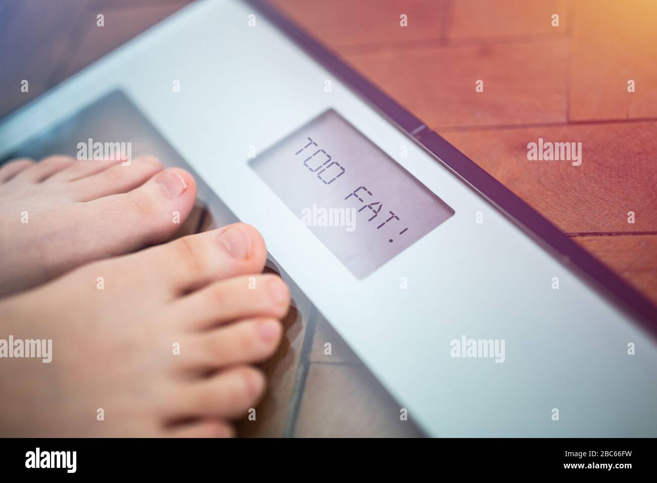 Feet on a scale, obesity becomes an increasingly common health problem ...