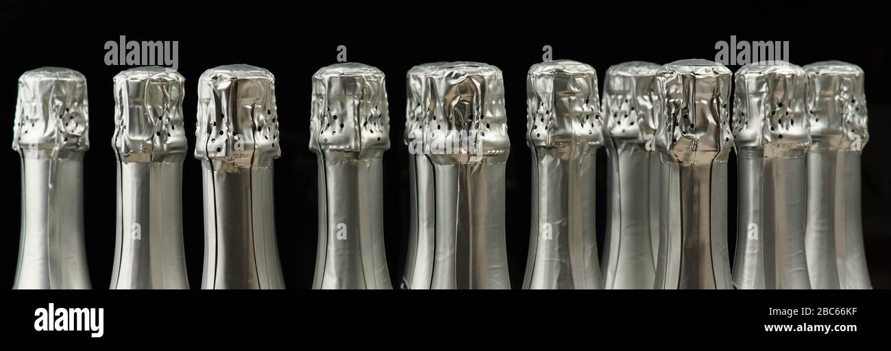 Silver champagne bottles isolated on black background Stock Photo - Alamy