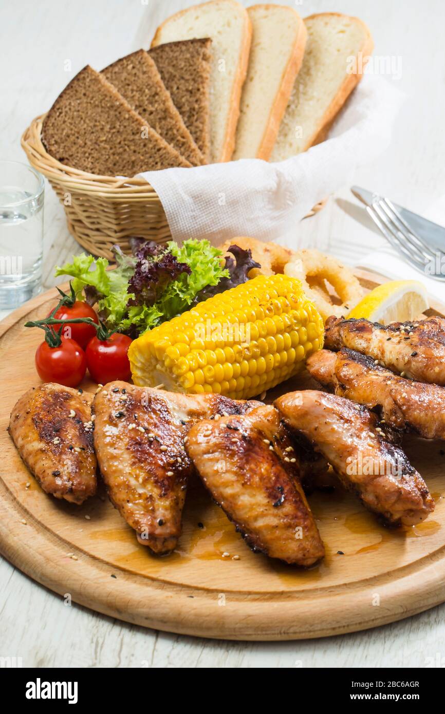 Grilled chicken wings with sweet corn. Close-up shot Stock Photo - Alamy
