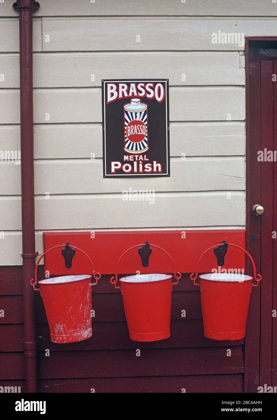 50s enamel advertising sign and fire buckets on Grosmont station, North ...