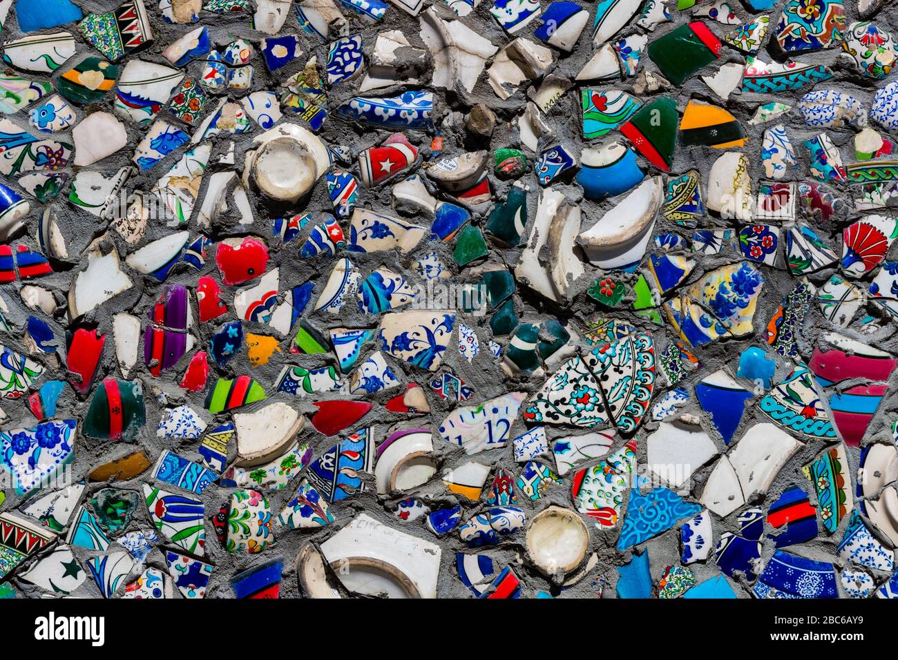 Wall with broken ceramic plates colored fragments Stock Photo - Alamy