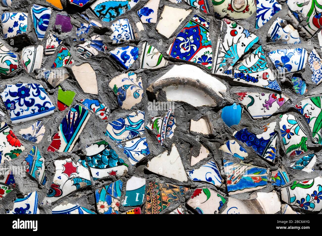 Wall with broken ceramic plates colored fragments Stock Photo - Alamy