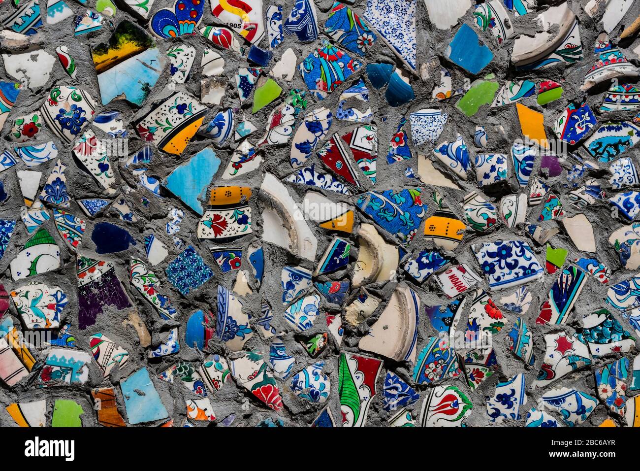 Wall with broken ceramic plates colored fragments Stock Photo - Alamy