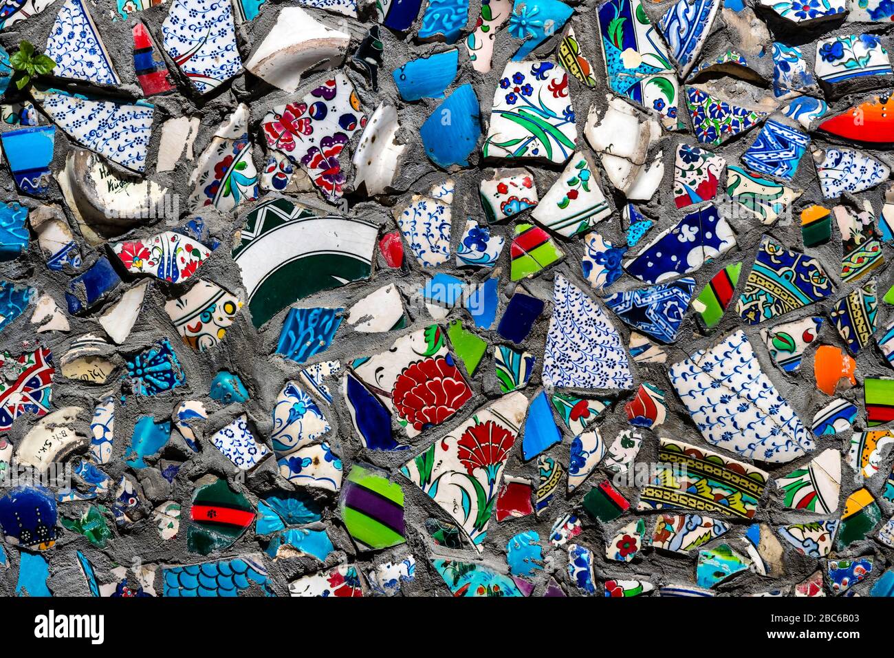 Wall with broken ceramic plates colored fragments Stock Photo - Alamy
