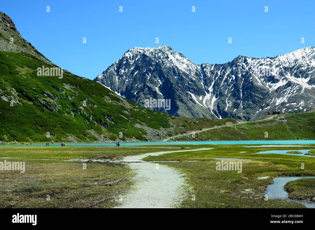 Austria, Tirol, people hiking around Rifflsee lake in Austrian Alps ...