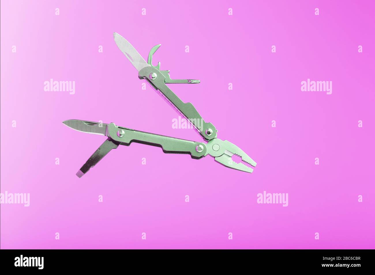 Multitool is a multi-functional tool on a pink background. The concept ...