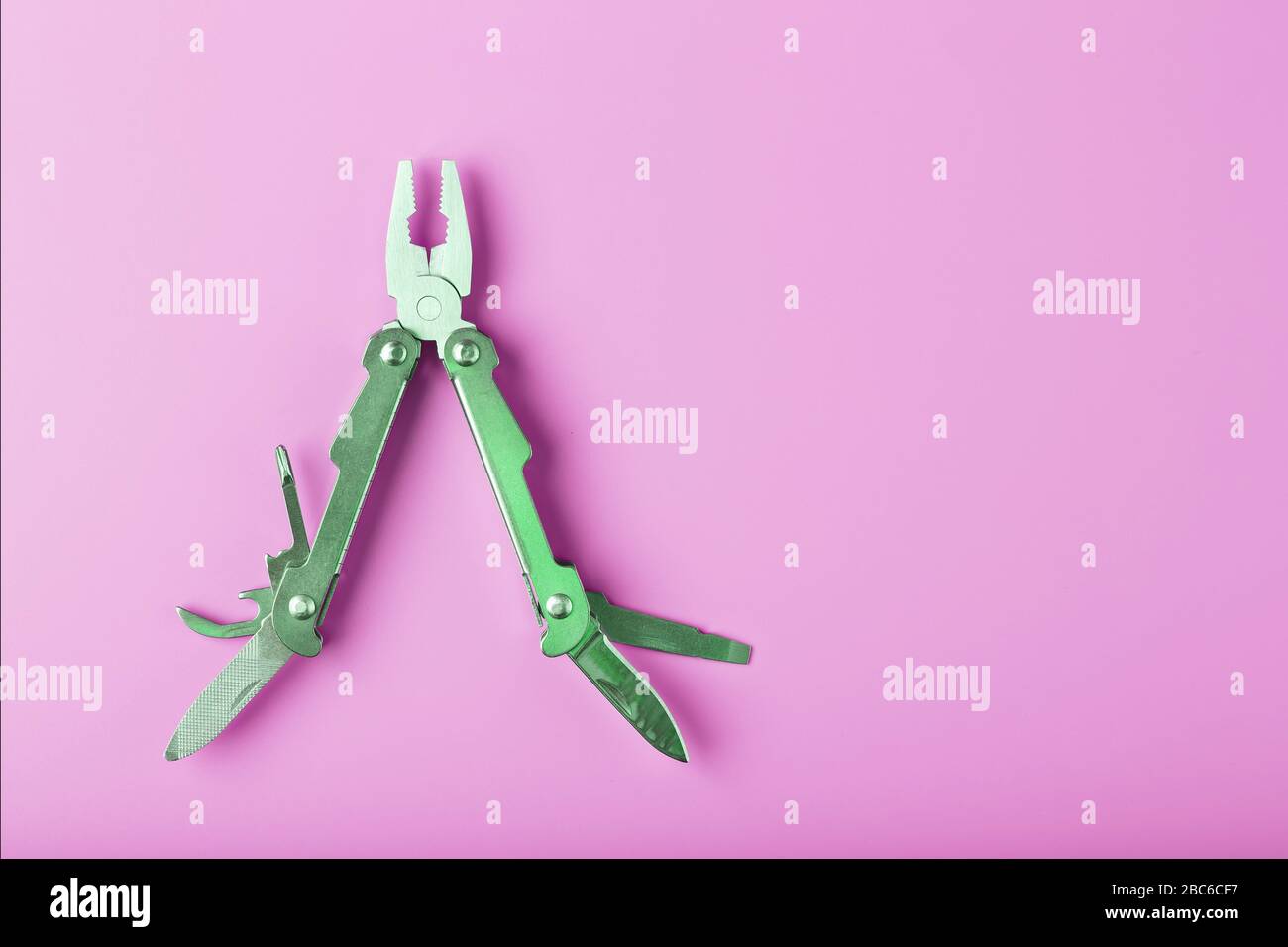 Multitool is a multi-functional tool on a pink background. The concept ...