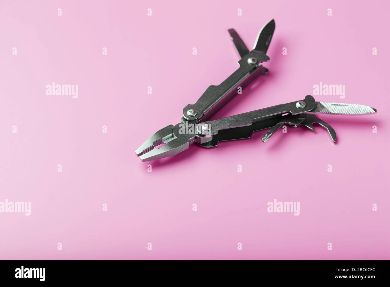 Multitool is a multi-functional tool on a pink background. The concept ...