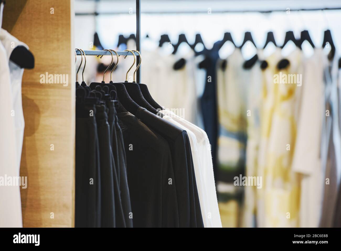 clothes on a rack in a store Stock Photo - Alamy