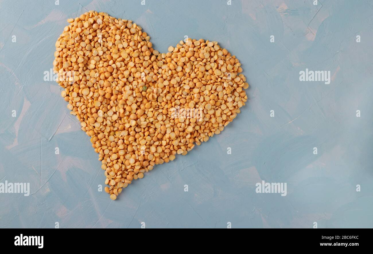 Heart shaped dried pea grain on a light blue background, Copy space ...