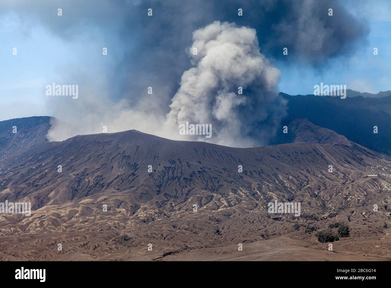 An Elevated View Of Mount Bromo (Erupting) and The Sea Of Sand, Bromo ...