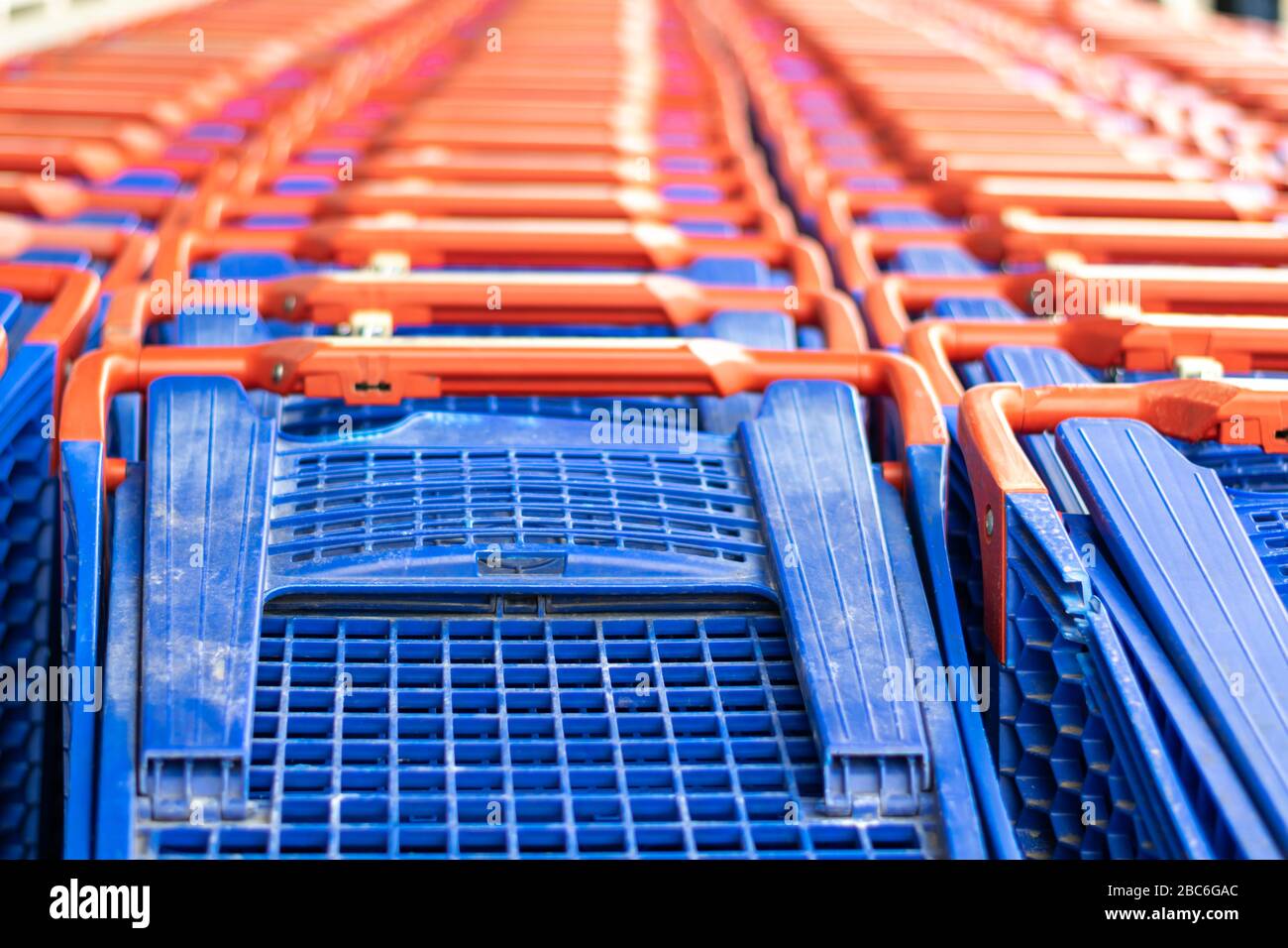 Shooping trolley row. Blue carts supermarket Stock Photo - Alamy