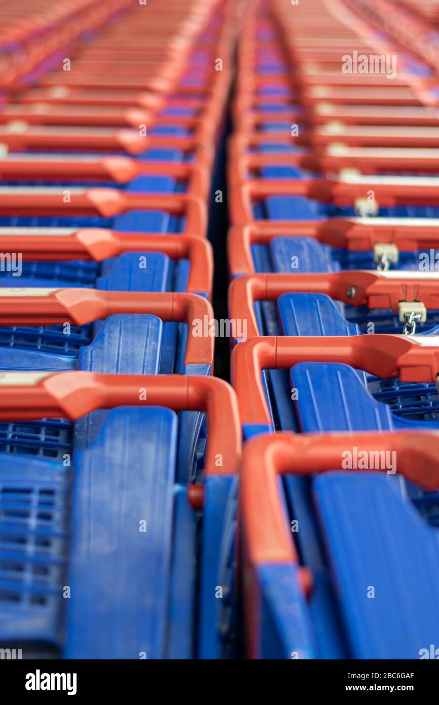 Shooping trolley row. Blue carts supermarket Stock Photo - Alamy