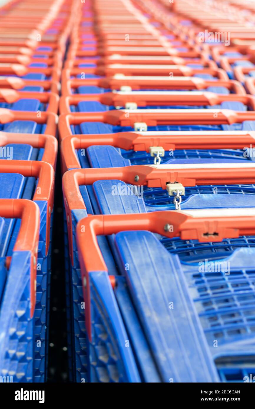Shooping trolley row. Blue carts supermarket Stock Photo - Alamy