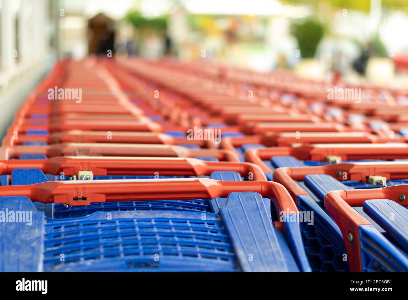 Shooping trolley row. Blue carts supermarket Stock Photo - Alamy