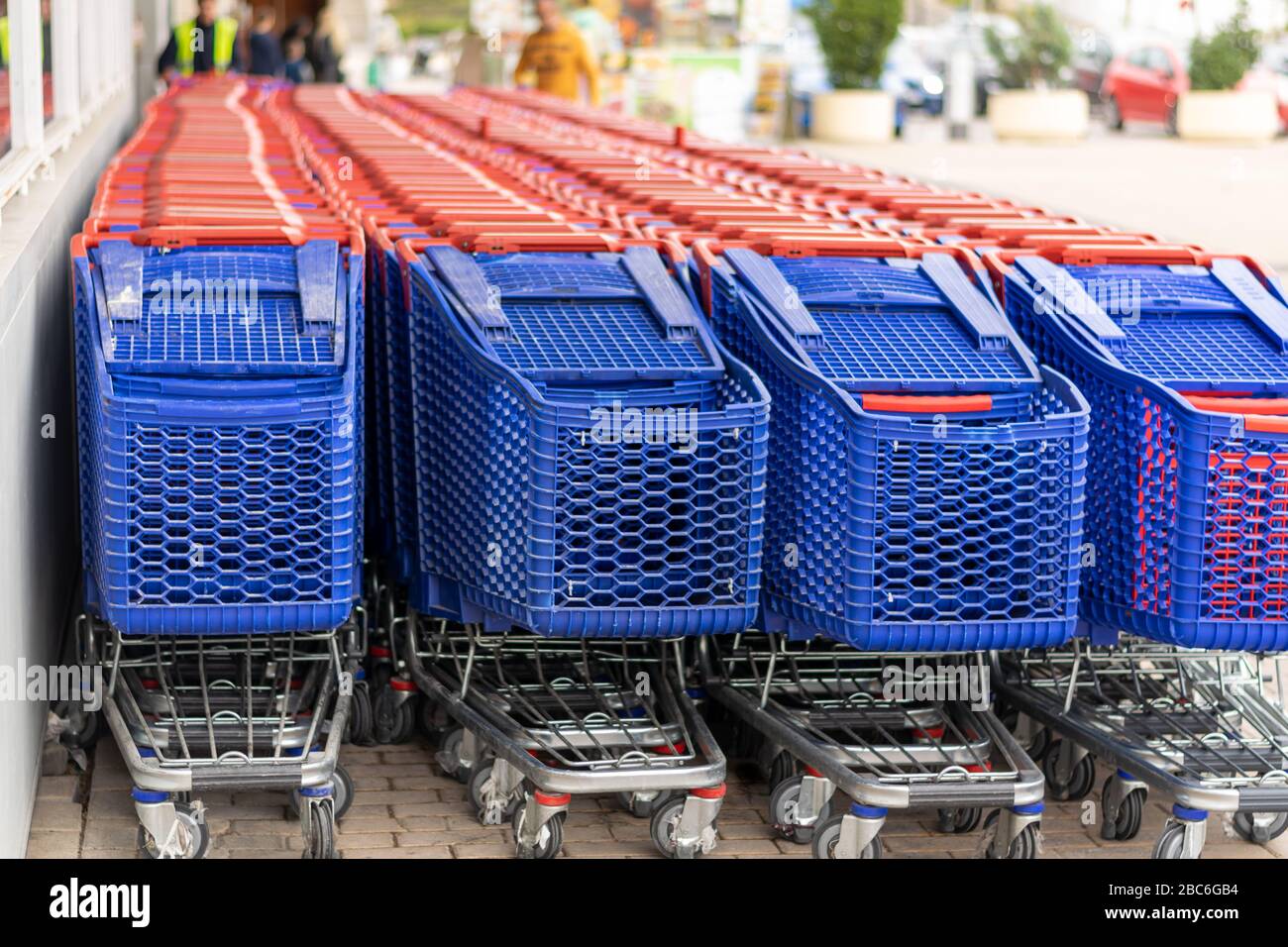 Shooping trolley row. Blue carts supermarket Stock Photo - Alamy
