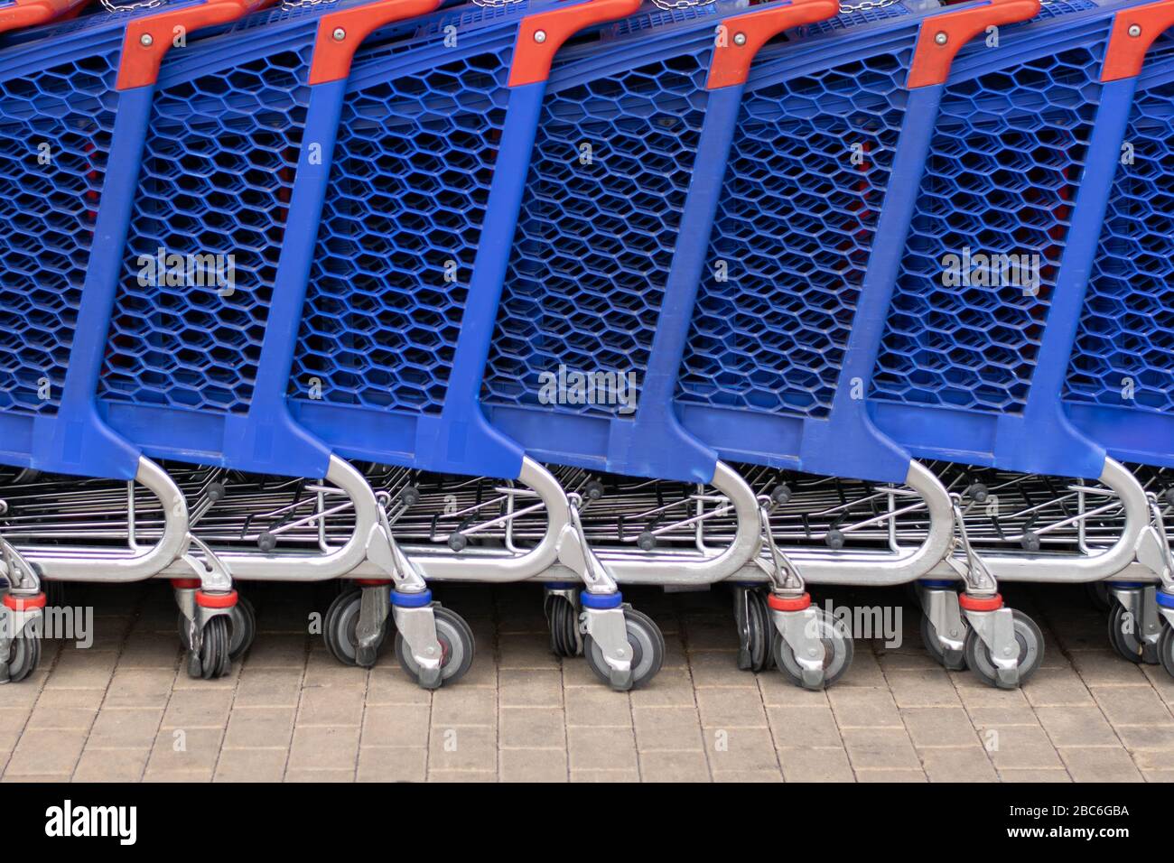 Shooping trolley row. Blue carts supermarket Stock Photo - Alamy