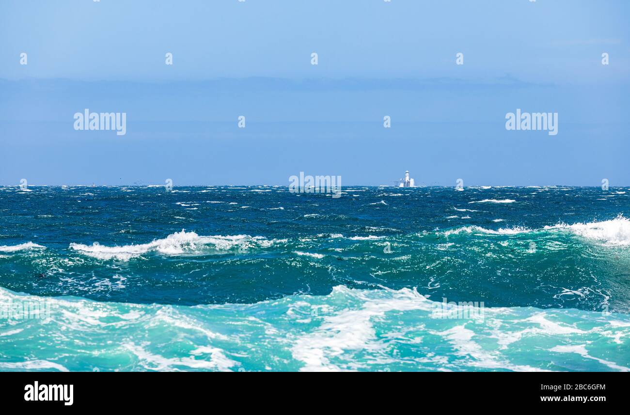 Roman Rock lighthouse in False Bay, Cape Town, on a windy rough seas ...