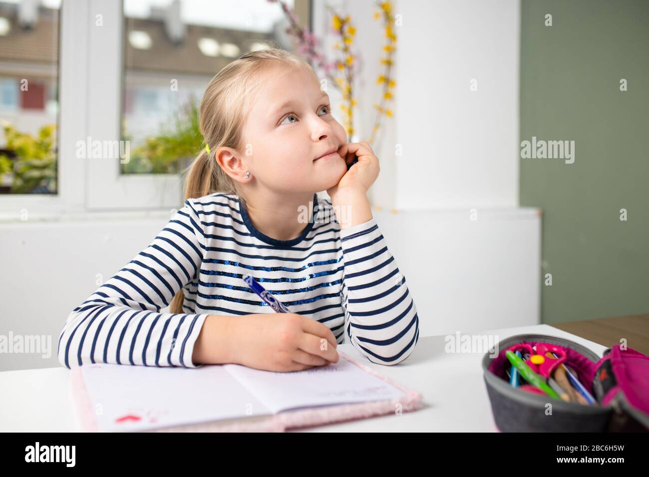 thoughtful student doing homework, pretty girl with blond hair Stock ...