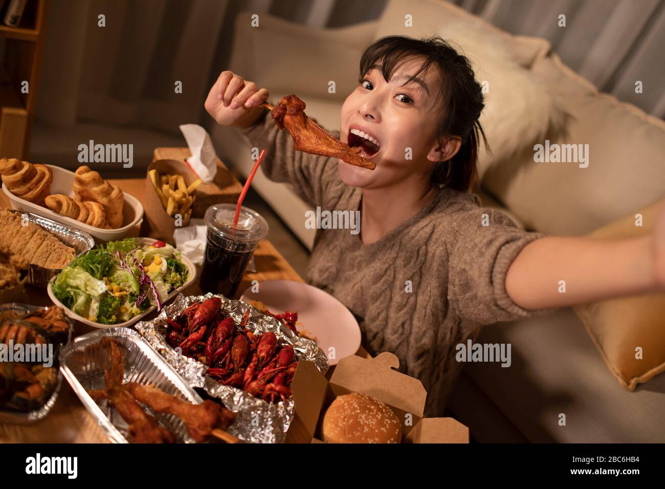 Young Chinese woman eating take-out food at night Stock Photo - Alamy