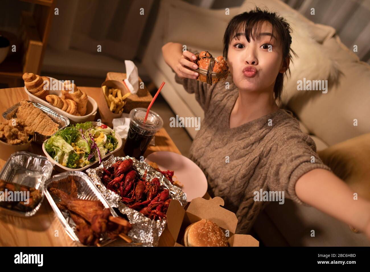 Young Chinese woman eating take-out food at night Stock Photo - Alamy