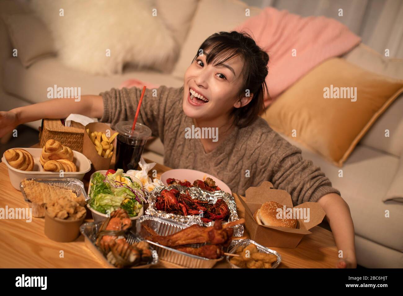 Young Chinese woman eating take-out food at night Stock Photo - Alamy