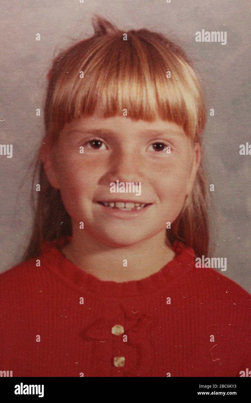 Formal grade school portrait of a beautiful young caucasian girl with ...