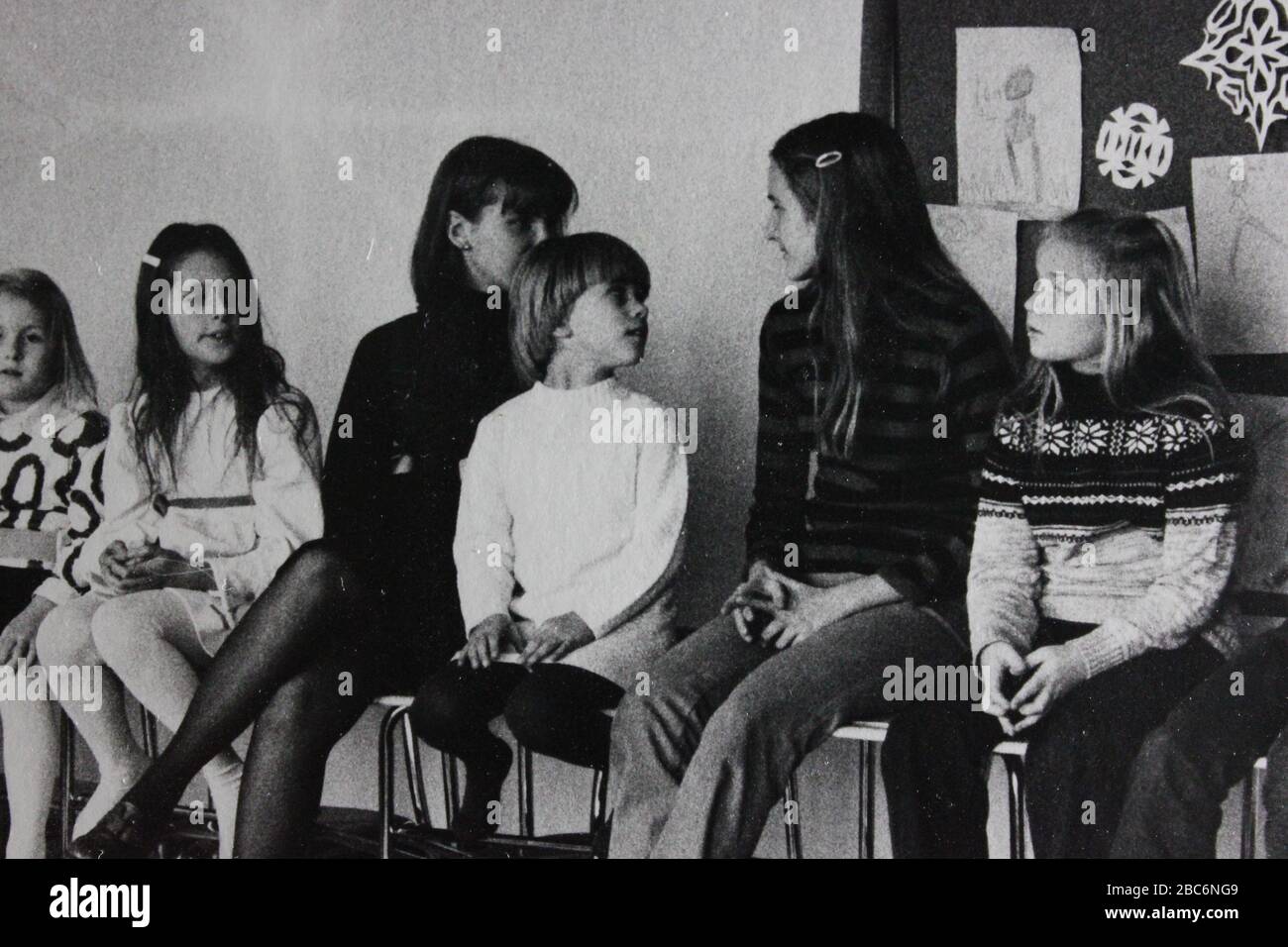 70s lifestyle portrait of kids sitting in a grade school class room ...